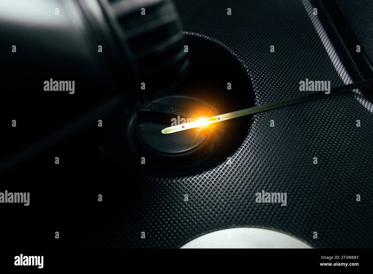 Car engine oil dipstick with reflective light on engine oil cap in a ...