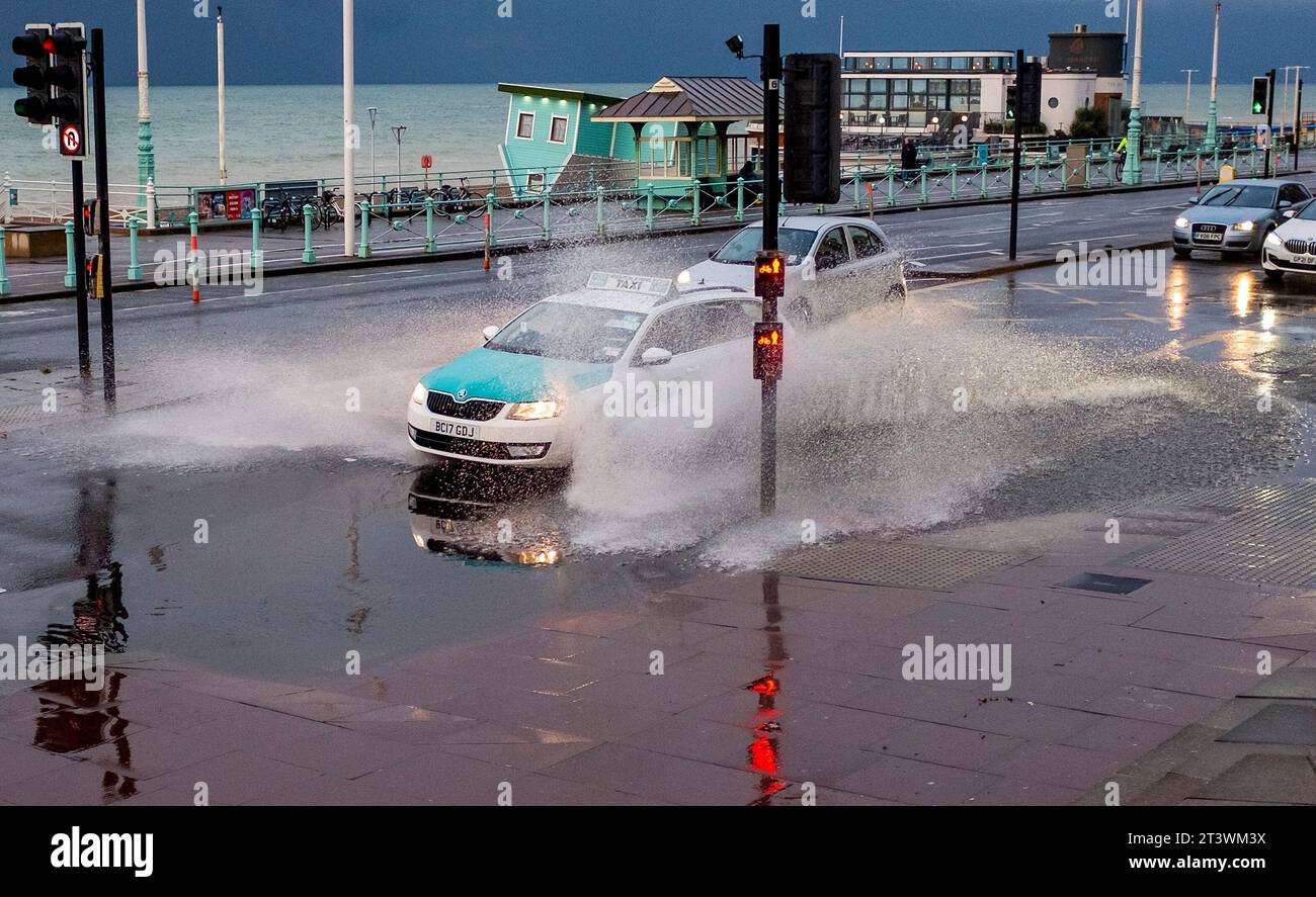 Brighton UK 27th October 2023 - Traffic splashes through floodwater on ...