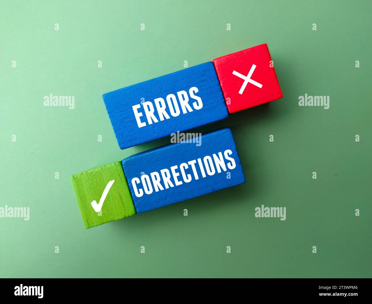 Top view colored wooden block with text CORRECTIONS ERRORS on green ...