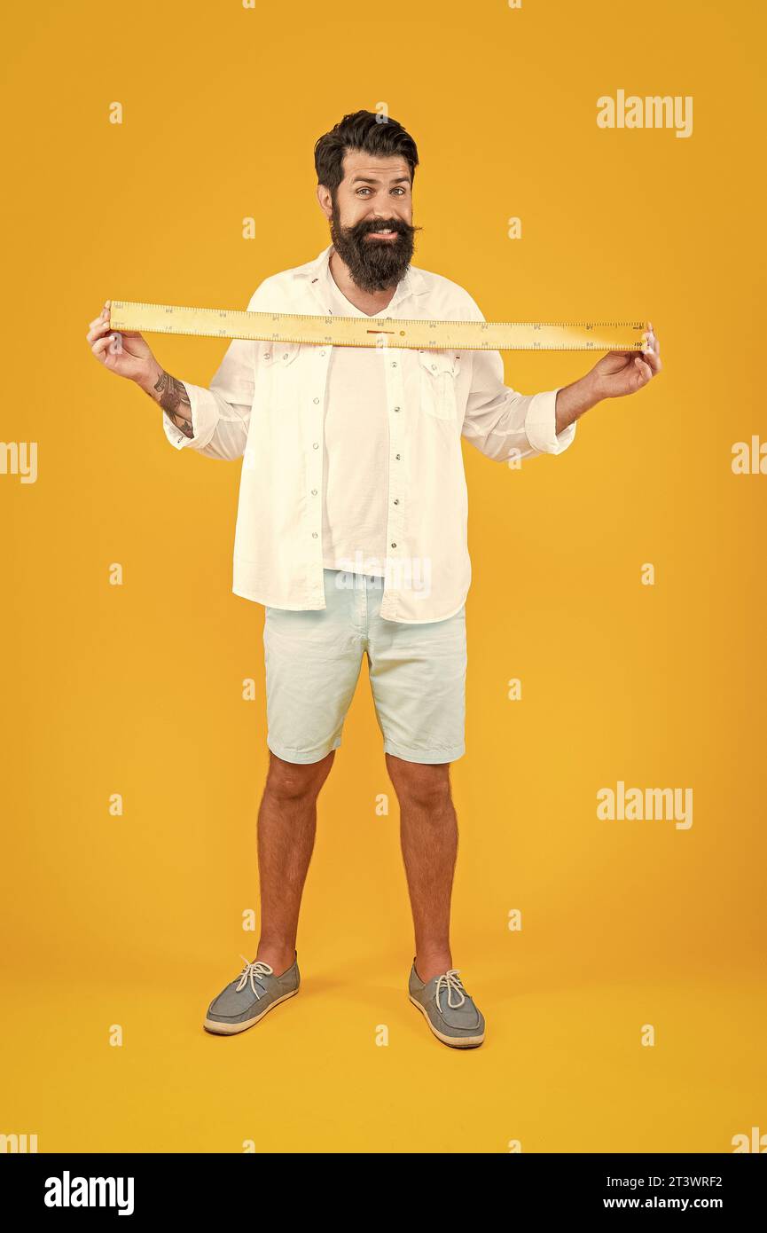 happy man with measuring ruler isolated on yellow. man with measuring ...