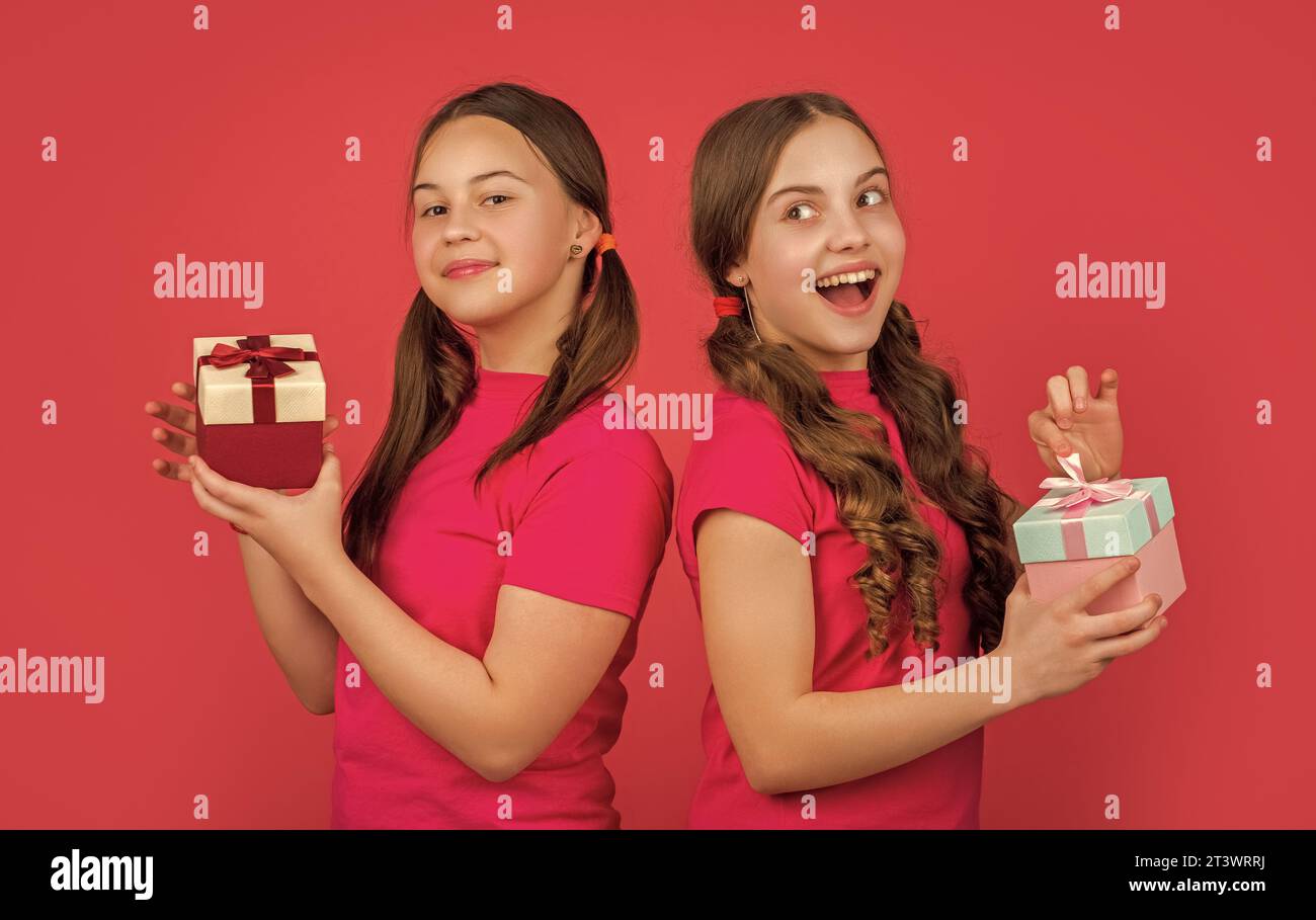 happy kids with present boxes on red background Stock Photo - Alamy