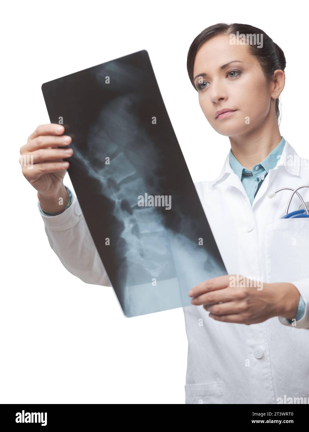 Confident female radiologist checking x-ray image of spinal column ...