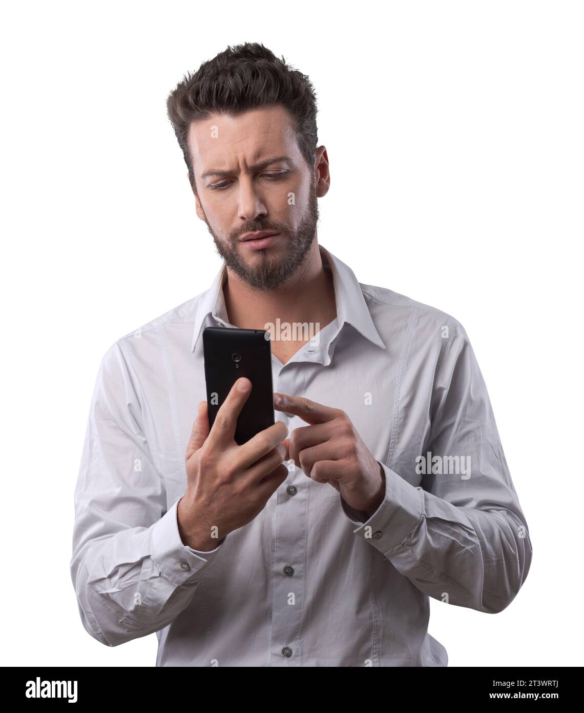 Disappointed young man typing on his touch screen smartphone Stock ...