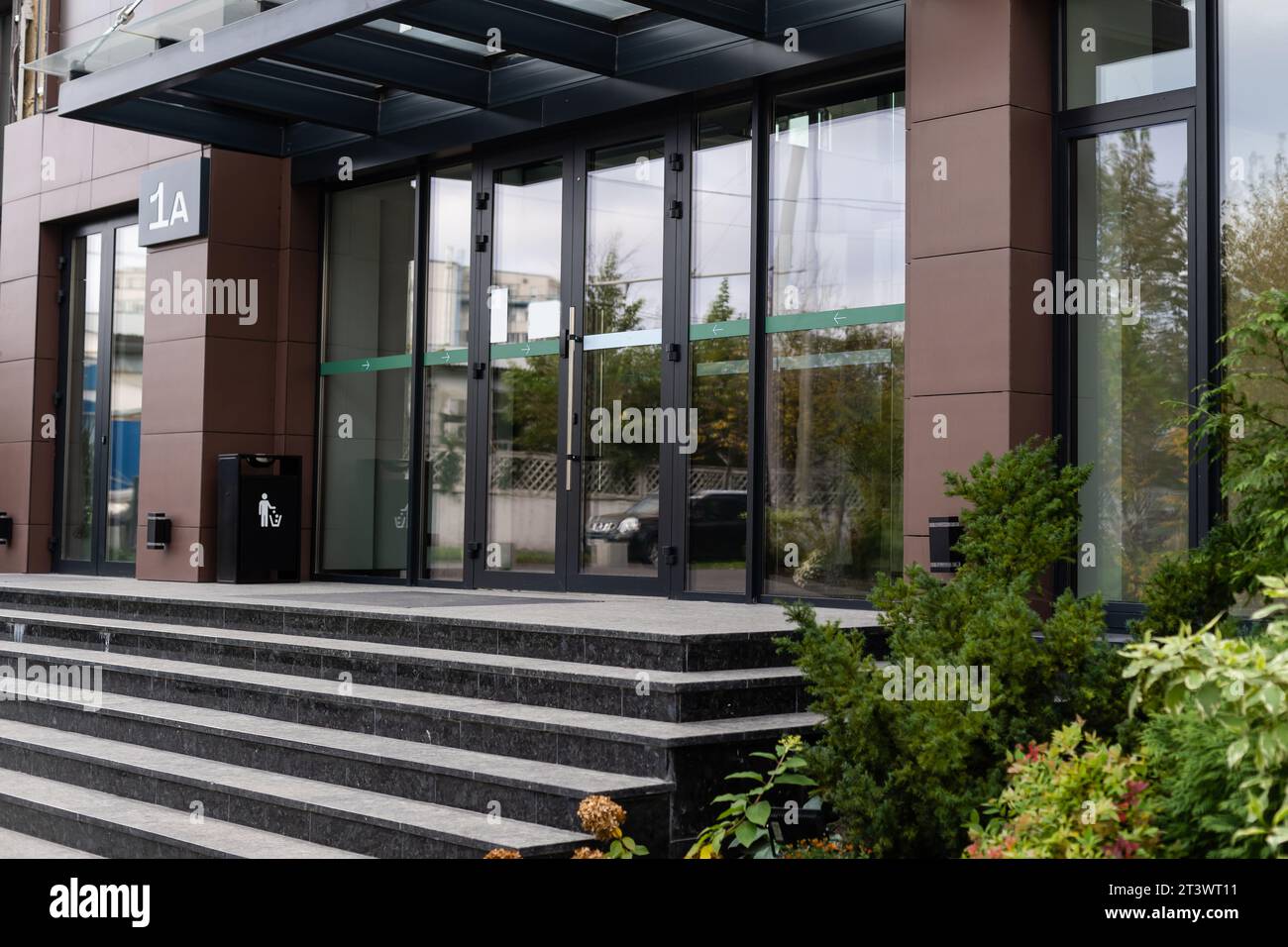 Outside solid glass door with building exterior Stock Photo - Alamy