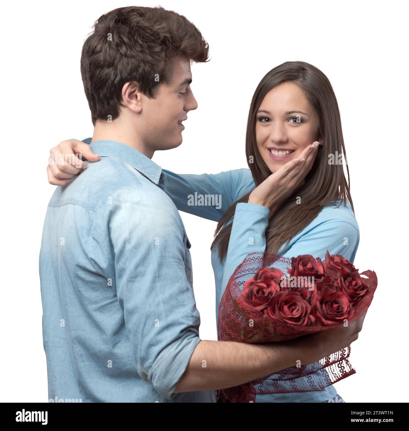 Smiling young woman receiving red roses as love gift from her boyfriend ...
