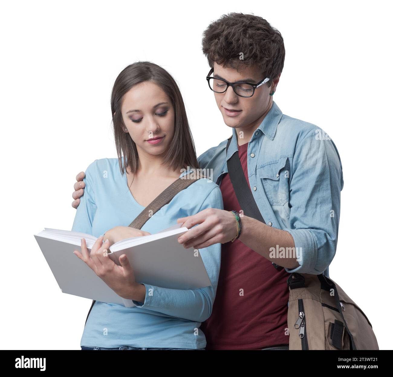 Happy students studying together on an open textbook and smiling Stock ...