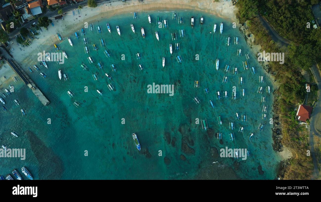 Top-down view of Padang Bai port on Bali island. Many small boats on ...