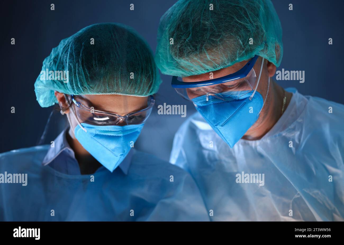 Male and female plastic surgeon in blue face mask Stock Photo - Alamy