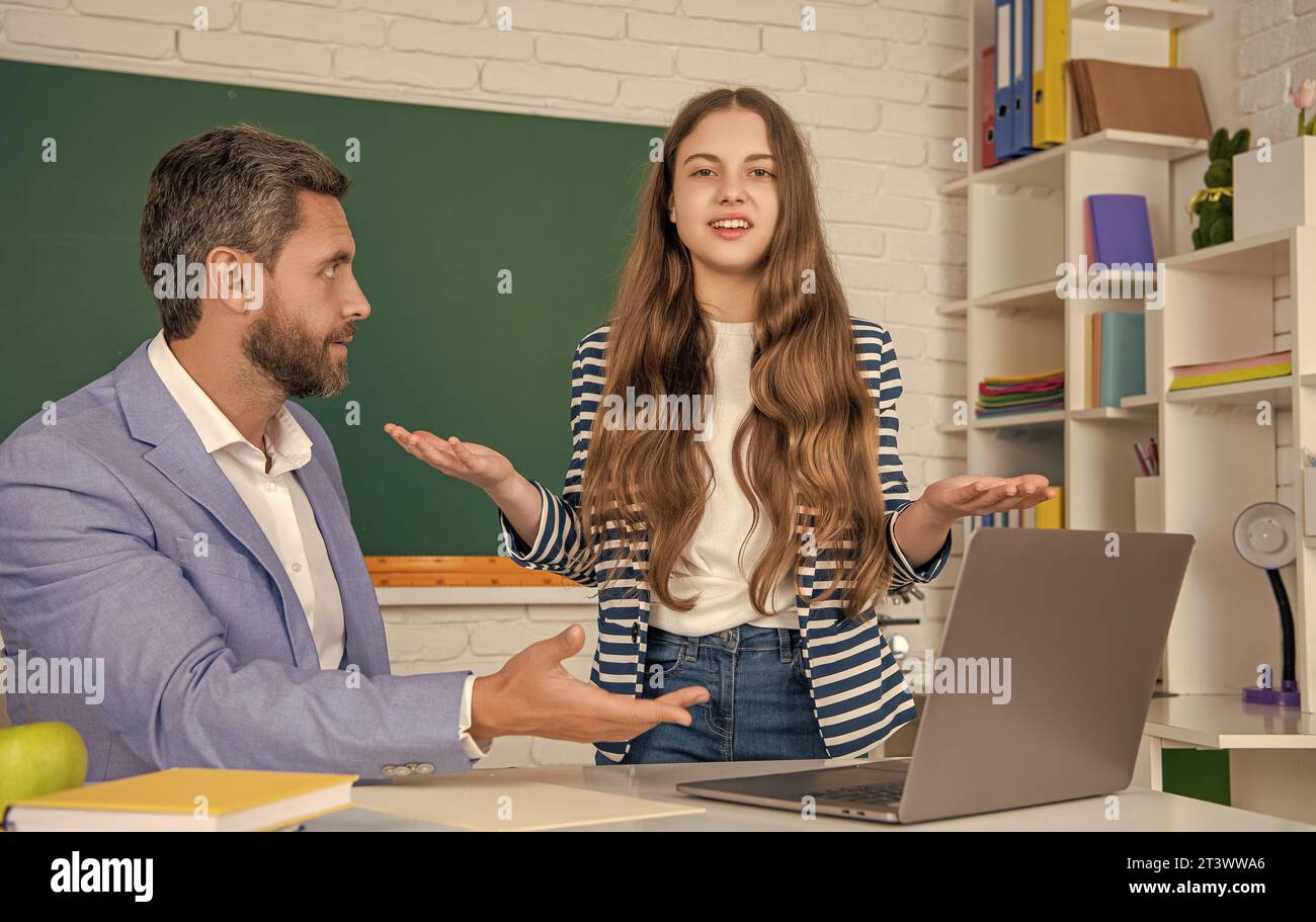confused child with man teacher in classroom. education Stock Photo - Alamy