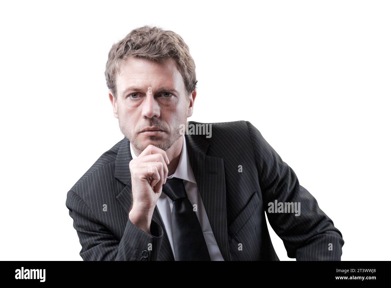 Confident business executive thinking with hand on chin and looking ...