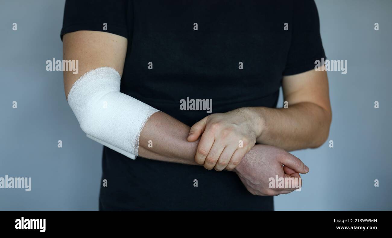 Male hand with tight elastic bandage on elbow closeup Stock Photo - Alamy