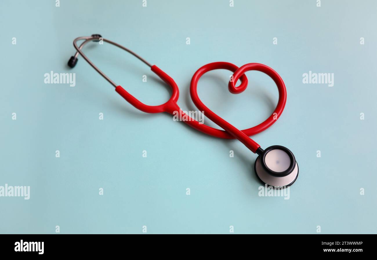 Red stethoscope with heart on blue modern background Stock Photo - Alamy