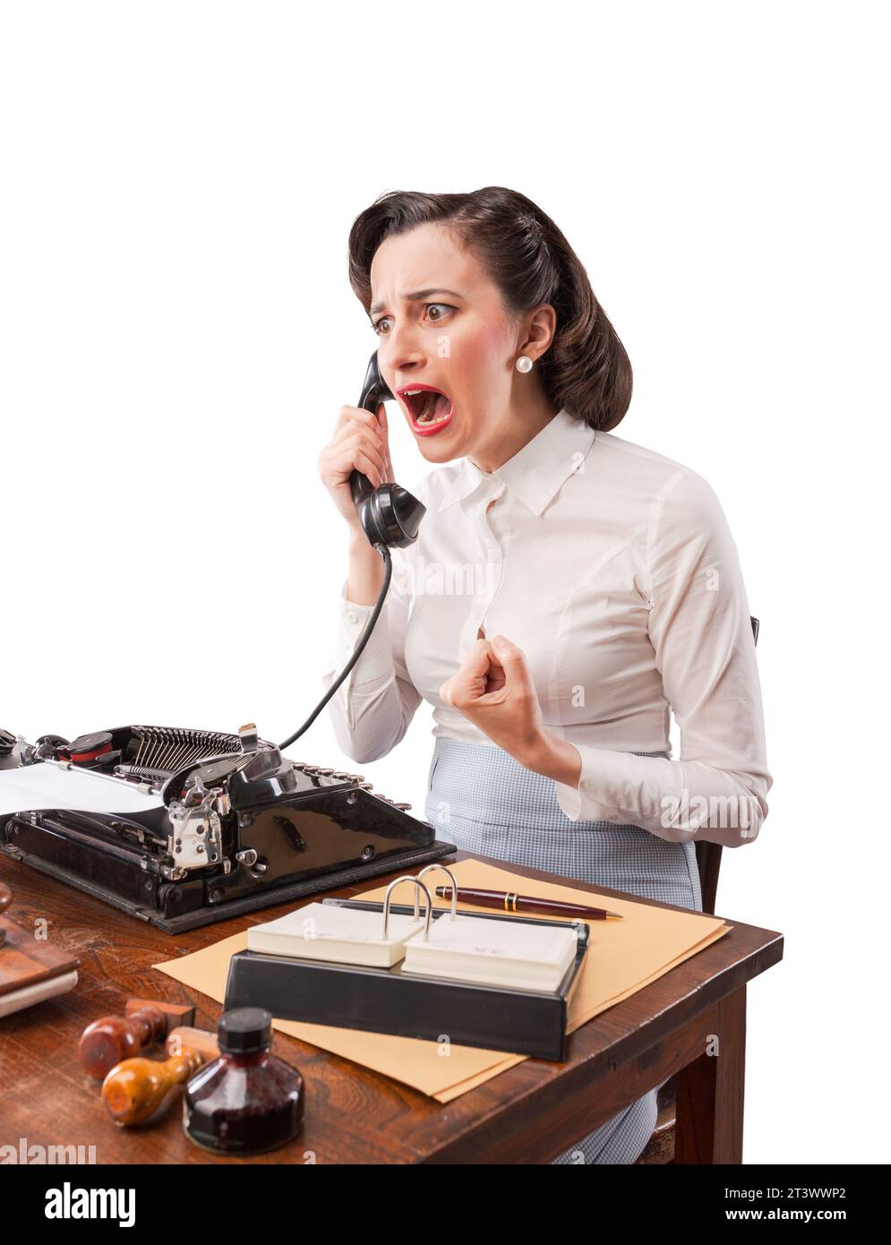 Stressed vintage style secretary sitting at office desk and yelling on ...