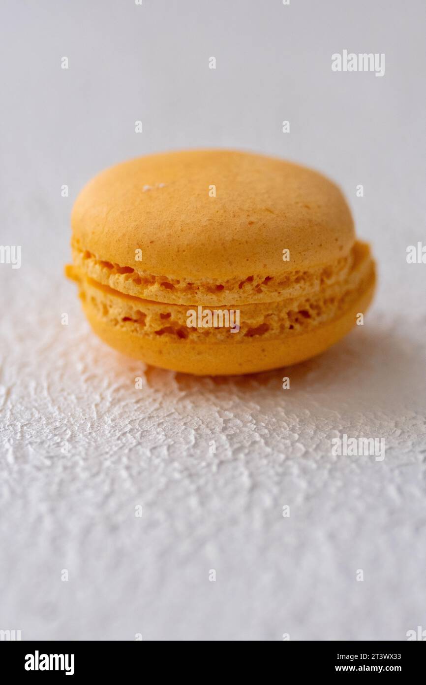 orange macaroon on white background in close-up Stock Photo - Alamy