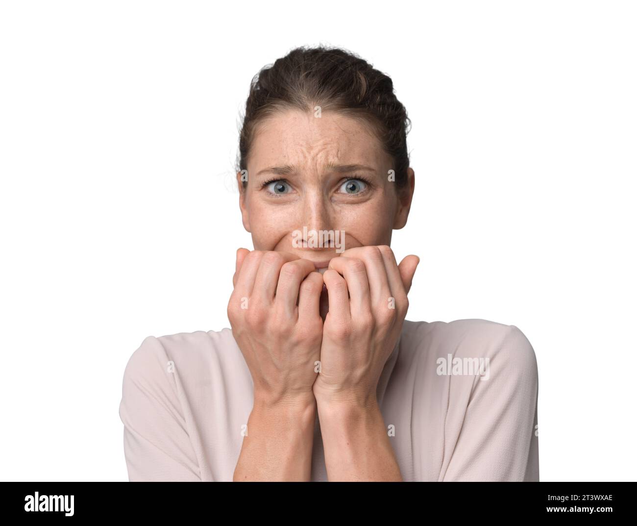 Terrified young woman looking at camera, she is feeling scared and ...