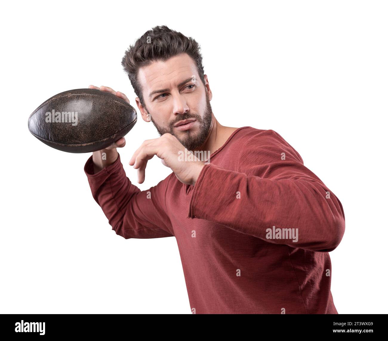 Handsome confident football player in red t-shirt launching ball Stock ...
