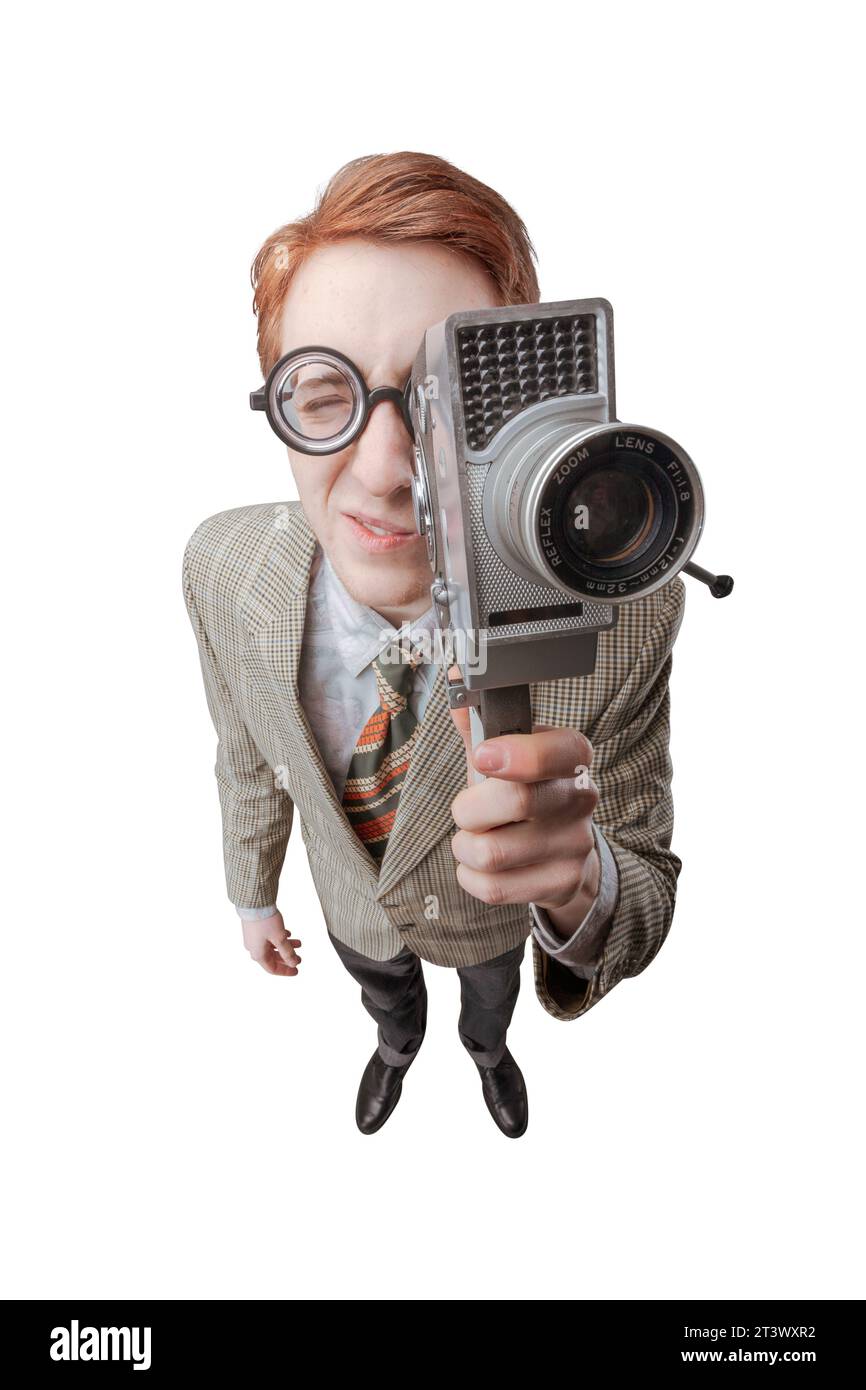 Funny nerd guy holding a vintage video camera and shooting a video ...