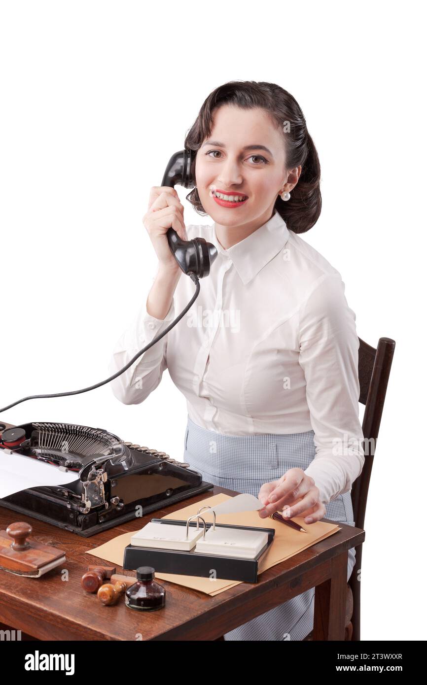 Beautiful smiling secretary sitting at desk and answering phone calls ...