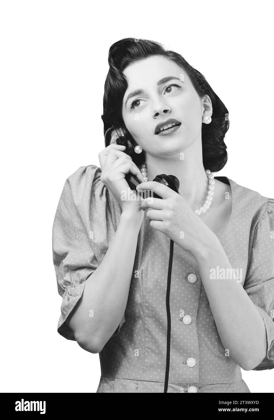 Vintage style woman holding the receiver and having a phone call, she ...