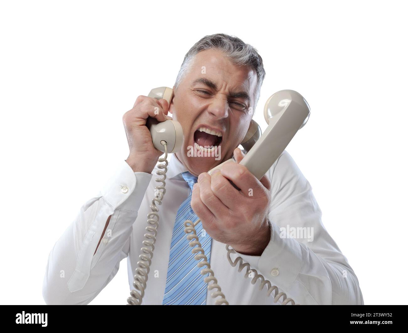 Stressed angry businessman holding many receivers and answering many ...