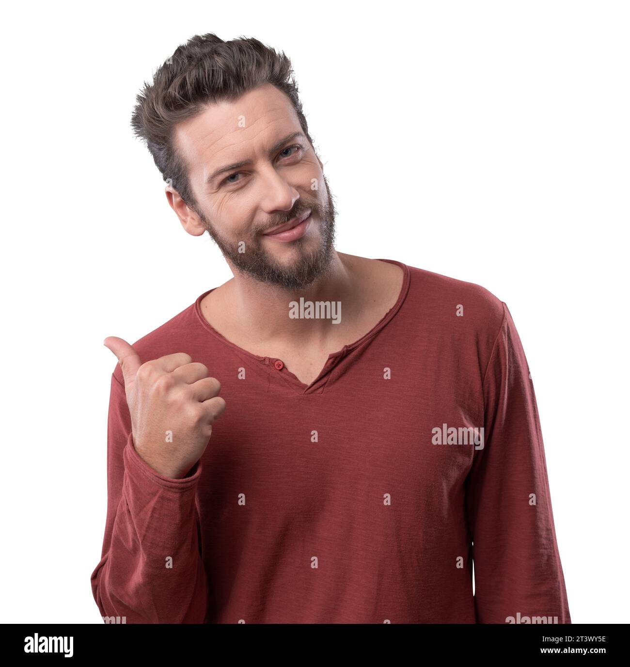 Confident young man smiling and pointing to his side Stock Photo - Alamy