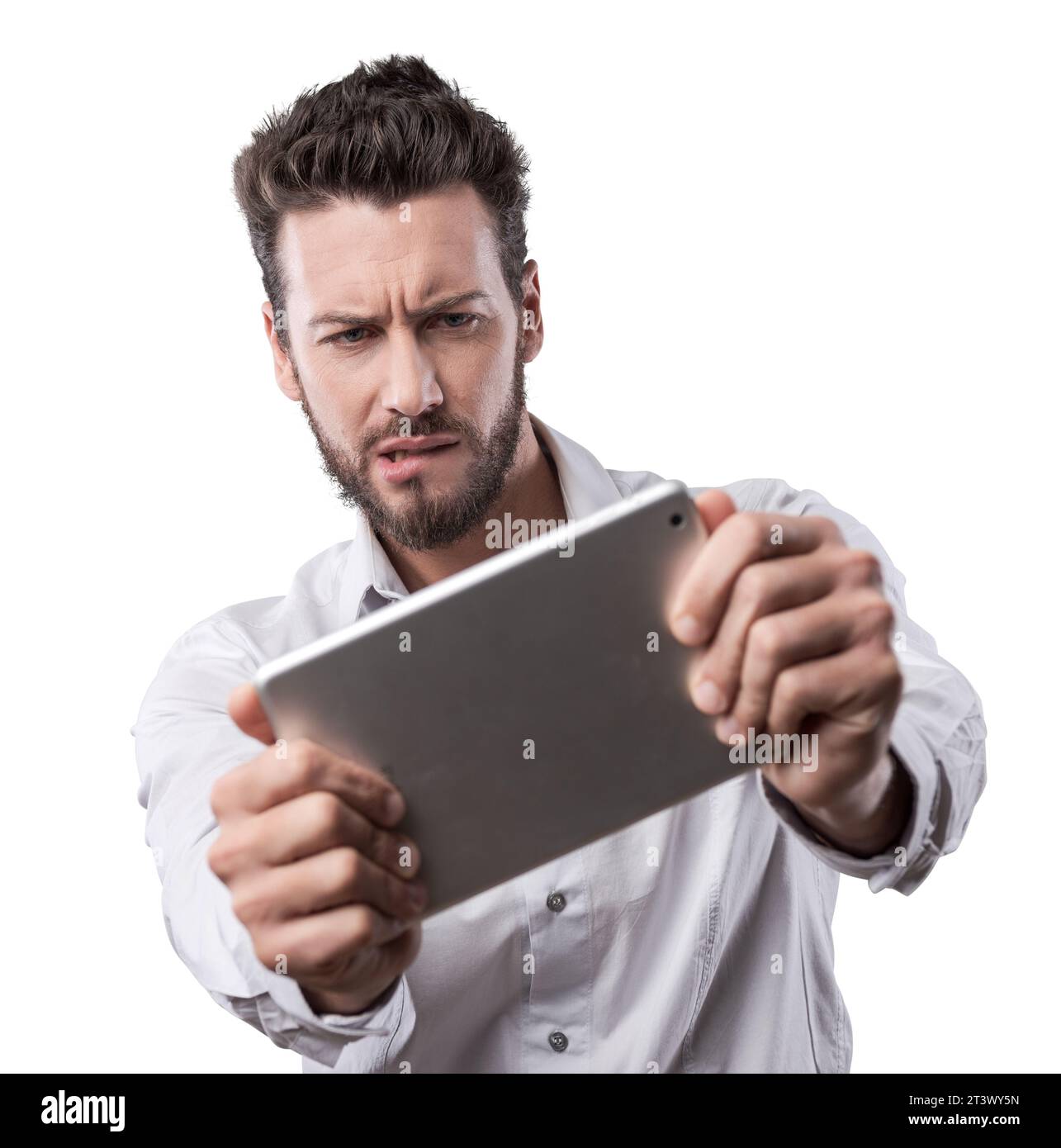 Confused man biting his lip and watching a digital tablet Stock Photo ...