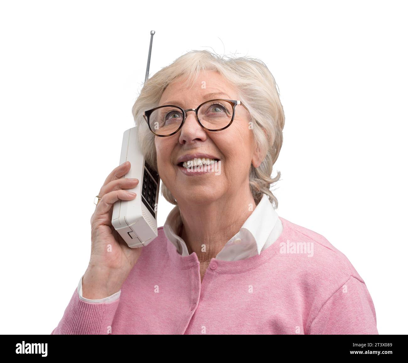 Happy senior woman talking with an old cordless telephone, she is ...