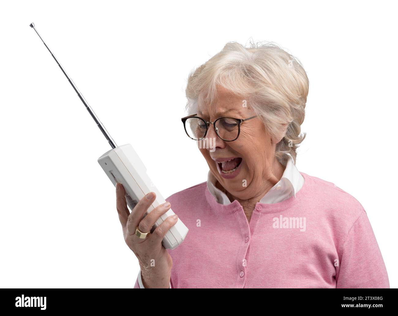 Frustrated senior woman using an old cordless telephone, she is ...