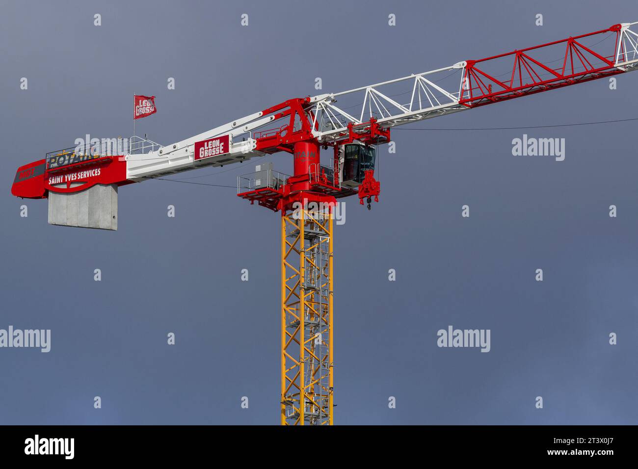Red white and yellow tower crane Potain MDT 389 L16 on stormy sky Stock ...