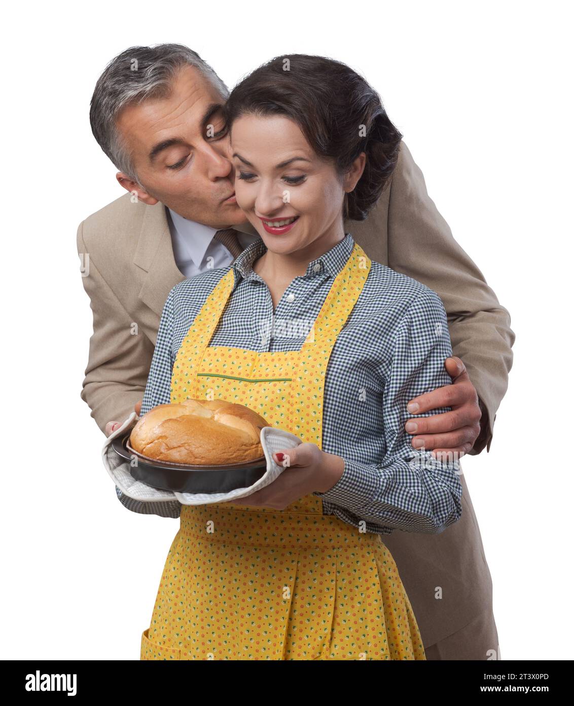 Vintage husband kissing her wife, she is holding a delicious home made ...