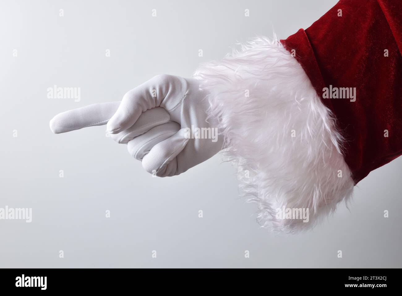 Santa claus hand with white glove and red traditional costume making ...
