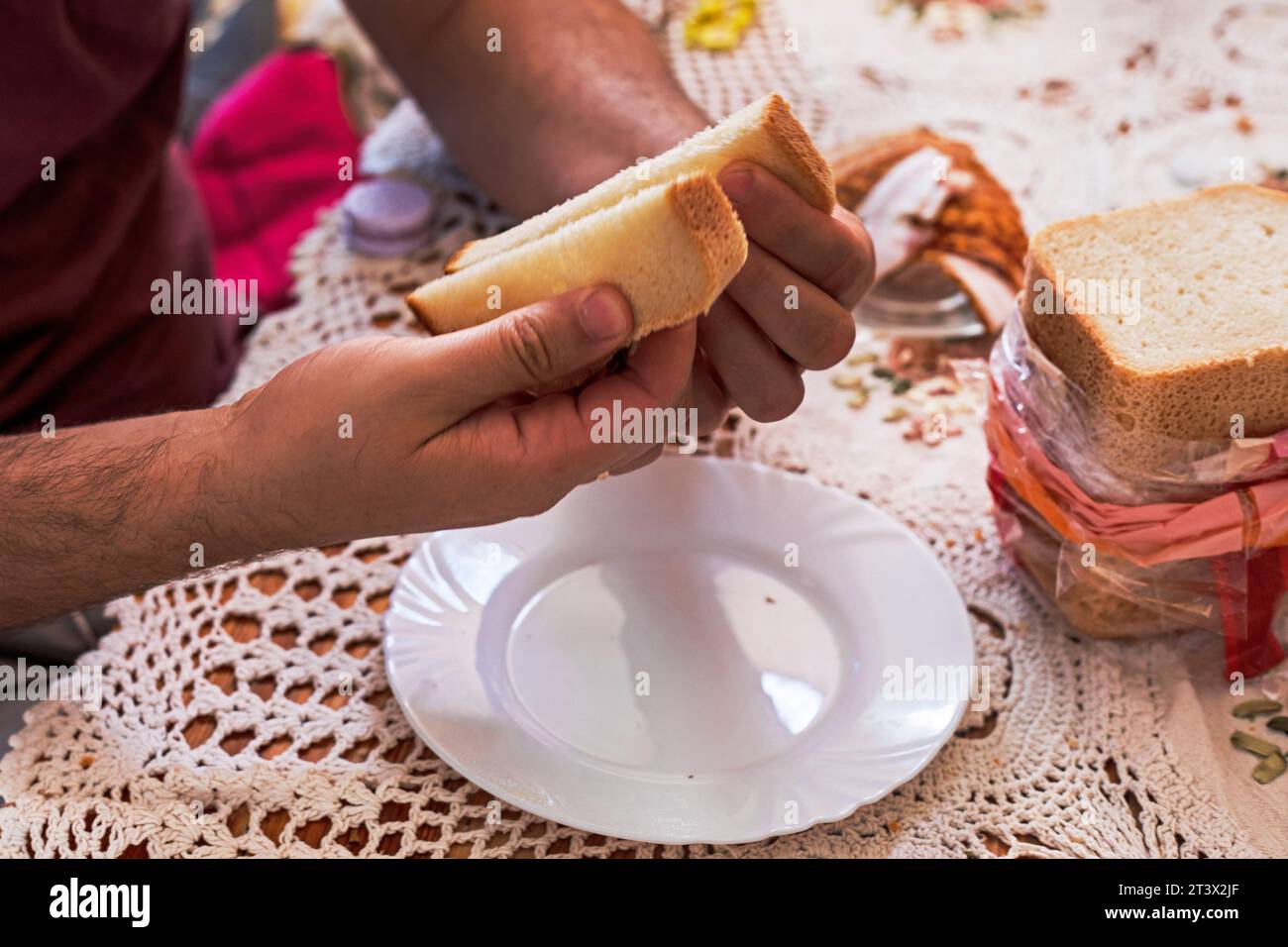 man holding pieces of sliced bread in his hands before breakfast Stock ...
