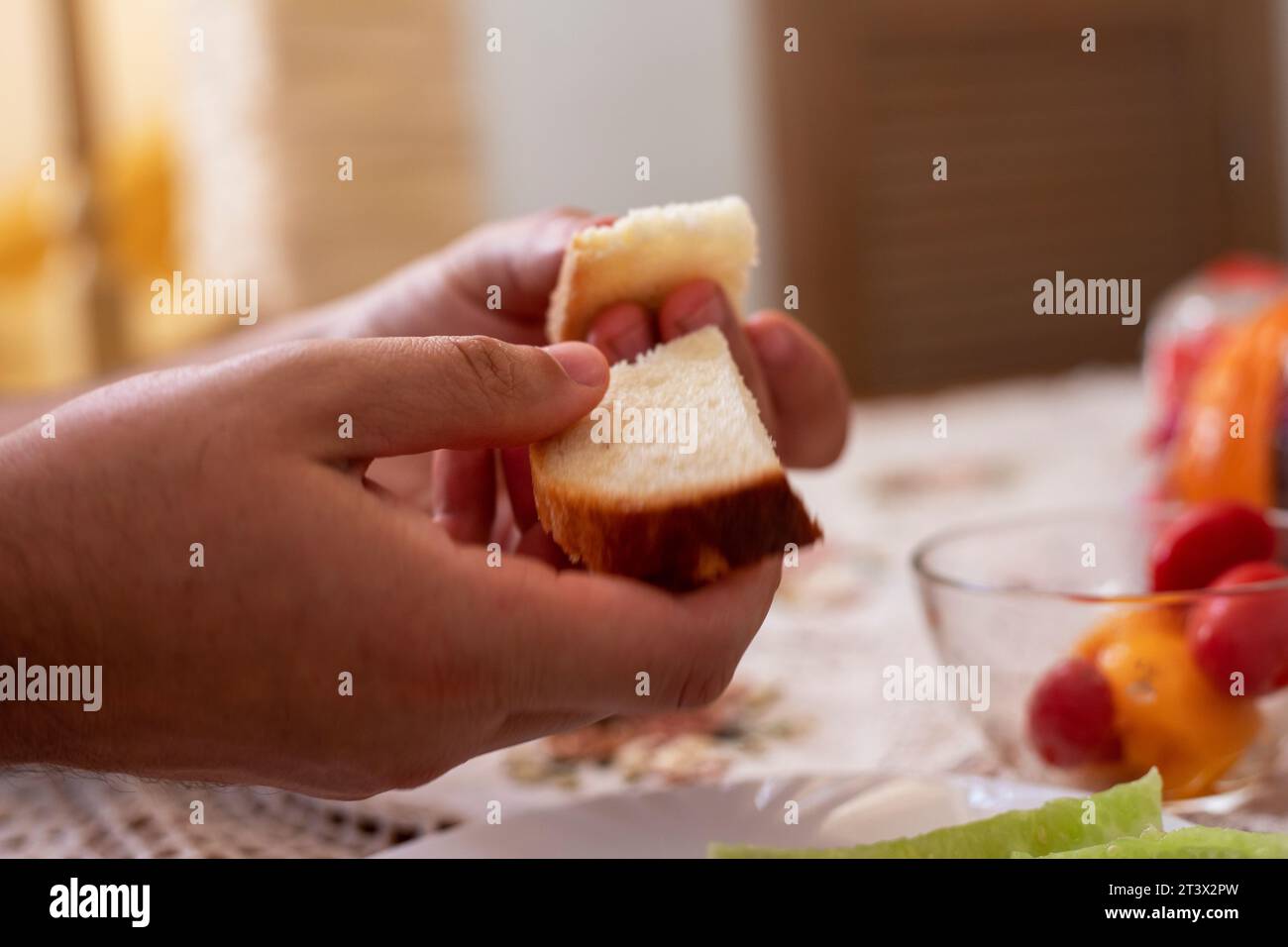 man holding pieces of sliced bread in his hands before breakfast Stock ...