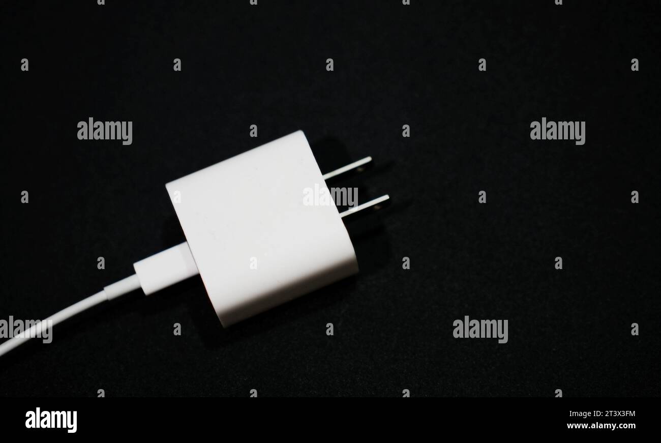 White phone charger with black background (Charger handphone Stock ...