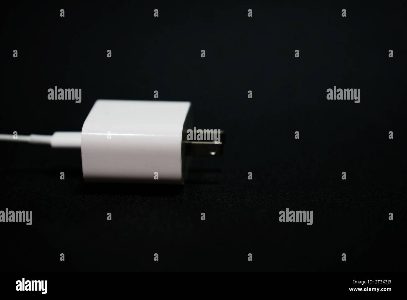 White phone charger with black background (Charger handphone Stock ...