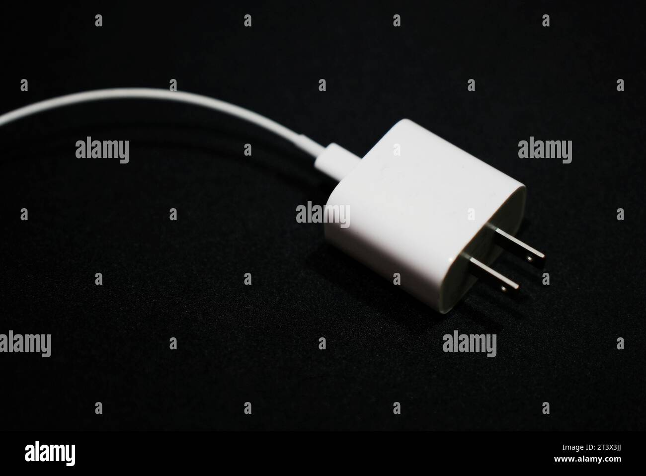 White phone charger with black background (Charger handphone Stock ...