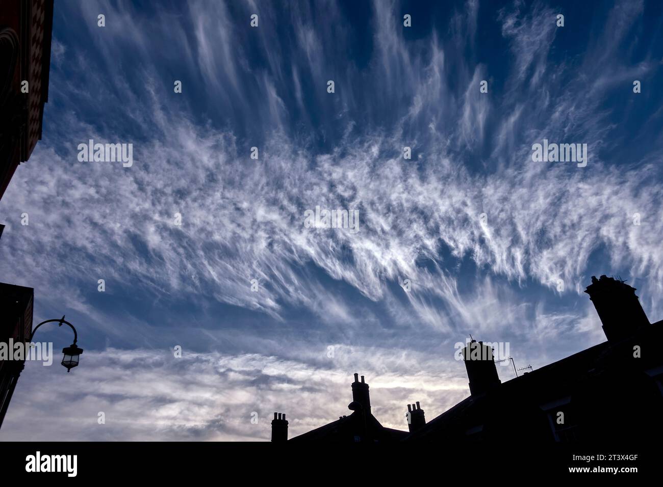 Cirrus clouds also known as mares tails, with houses below. England UK ...