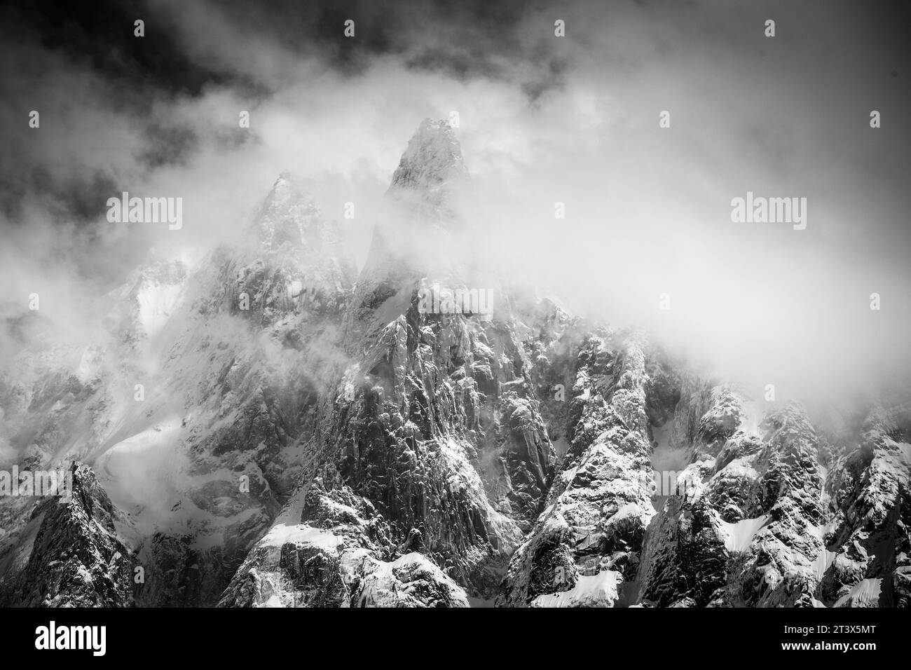 A black and white photo of a jagged rock mountain Stock Photo - Alamy