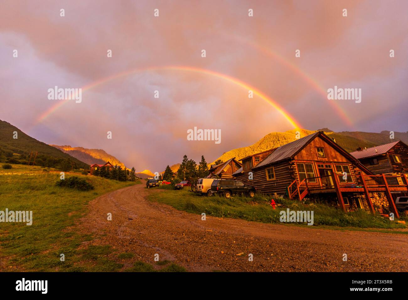 Rainbow over a cabin Stock Photo - Alamy