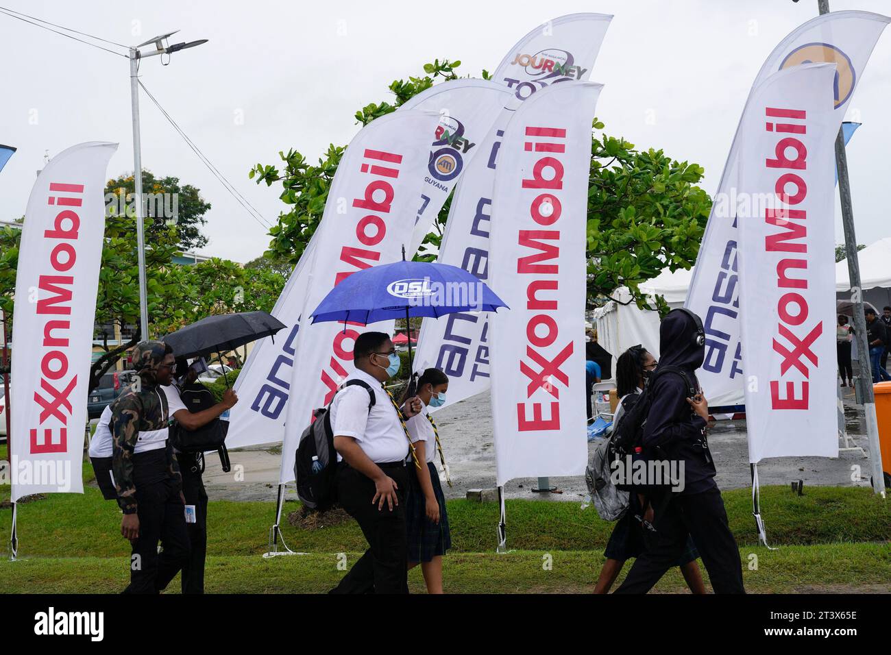 File - High school students walk past ExxonMobil flags as they arrive ...