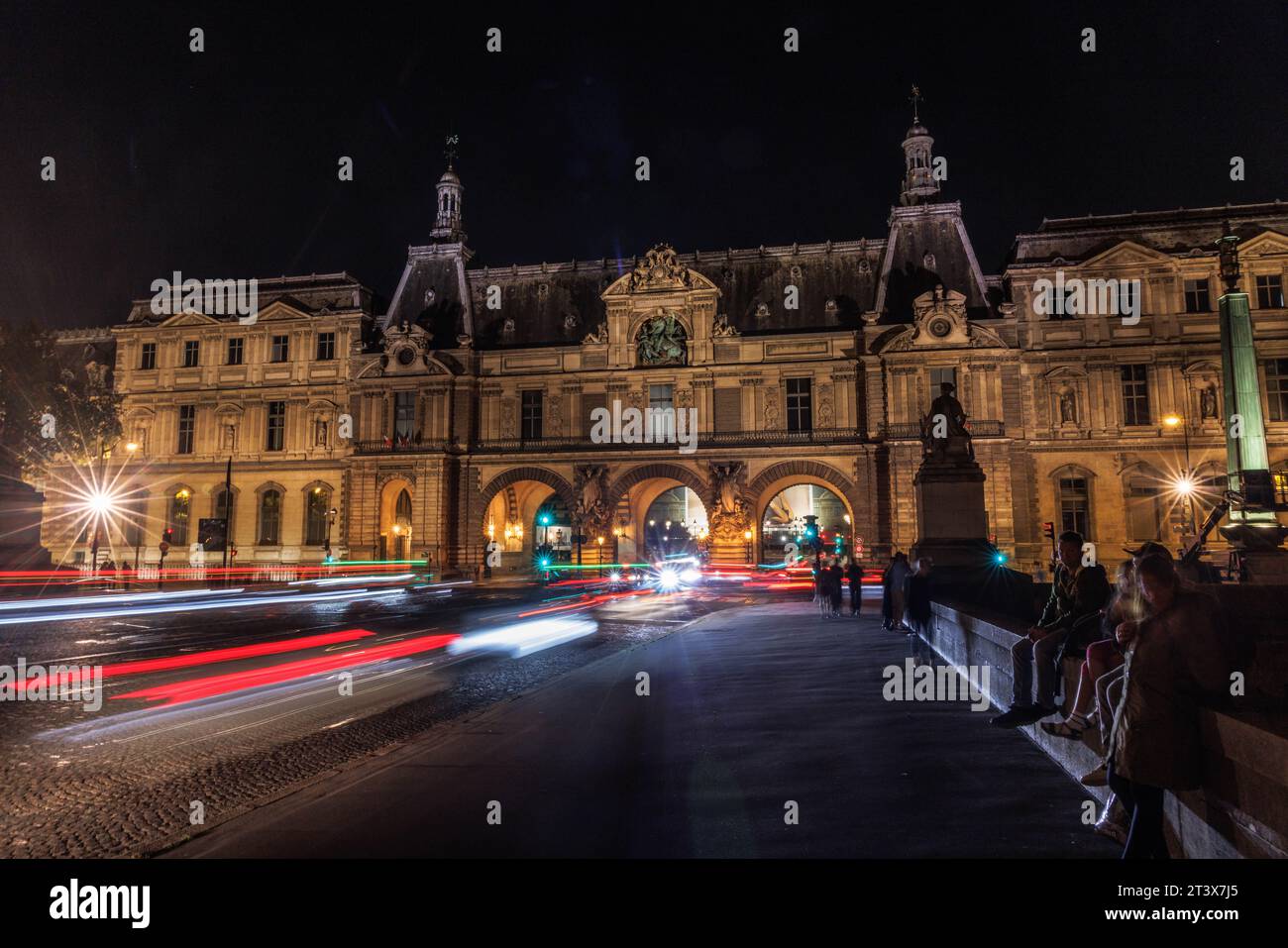 Long exposure scene at night of the Louvre Museum in Paris, France ...
