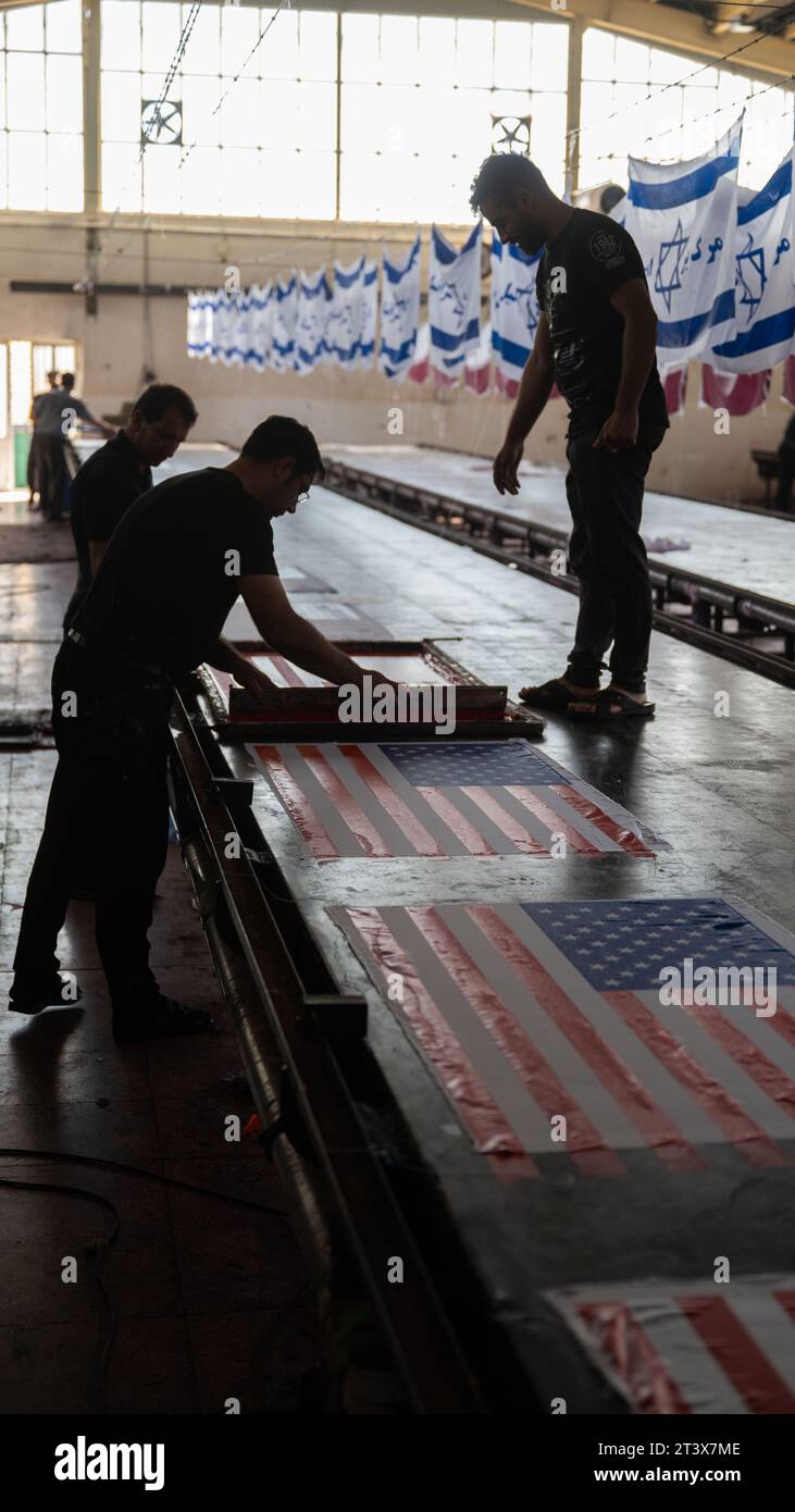 Chomein, Iran. 27th Oct, 2023. Employees of a flag factory work on a ...