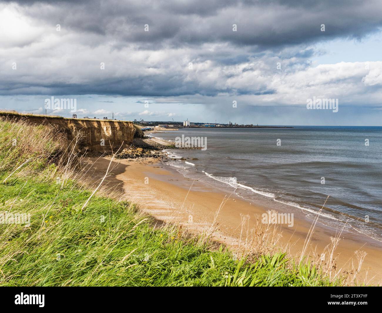 Beaches and cliffs at Sunderland, UK with view to Sunderland docks ...