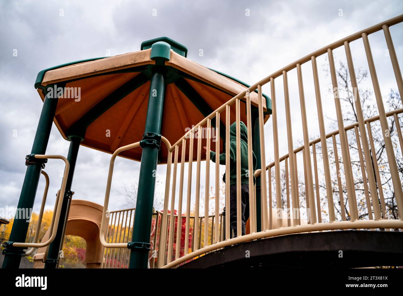 Toddler Boy Walking on Playground Bridge on Cloudy Day Stock Photo - Alamy
