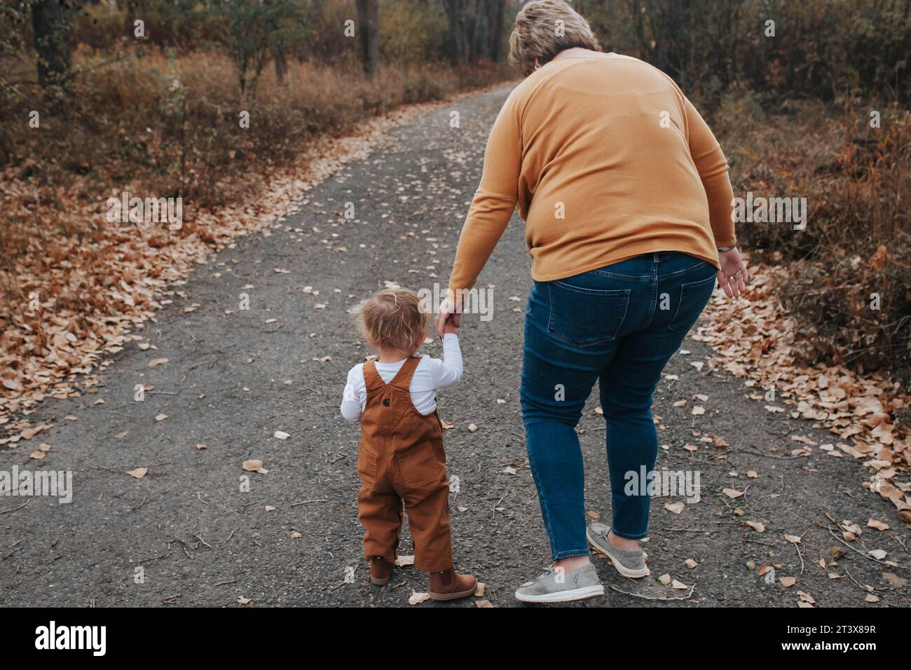 Grandma and 2-year-old grandson walk in fall Stock Photo - Alamy