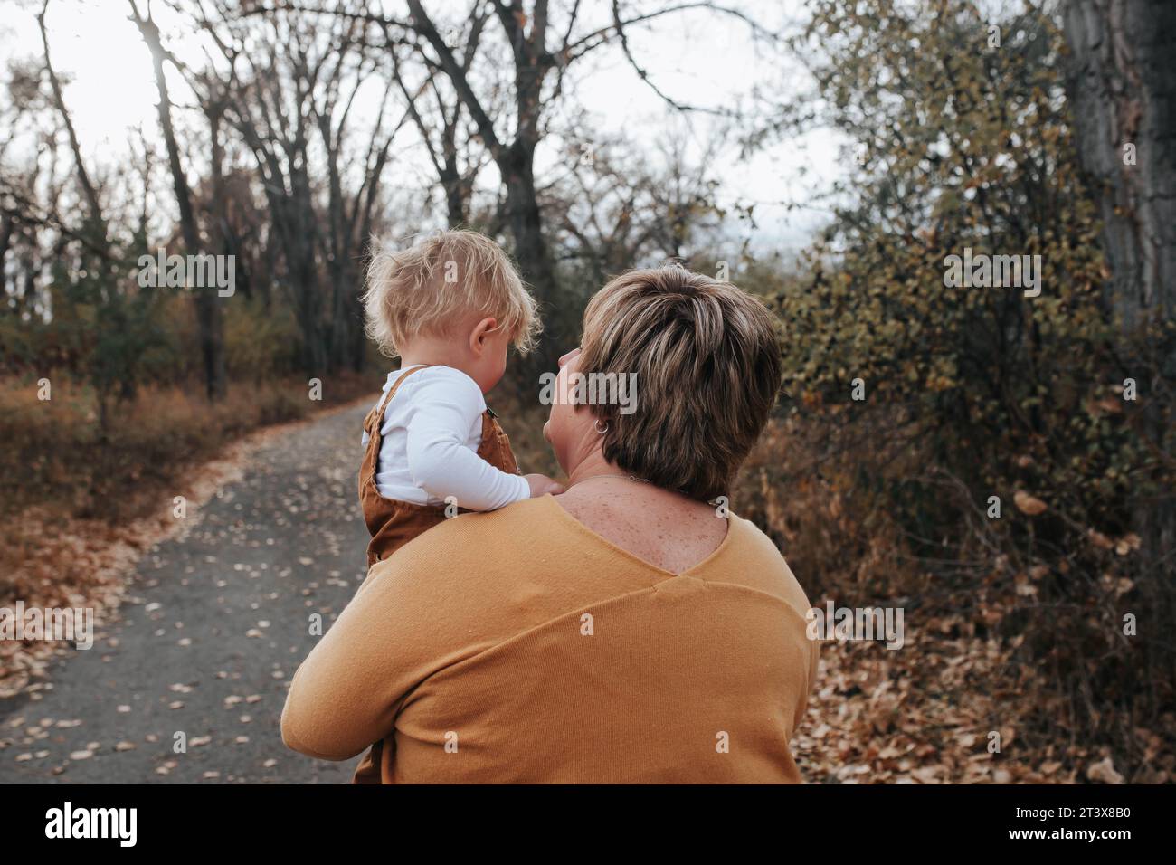 Grandma and 2-year-old grandson walk in fall Stock Photo - Alamy