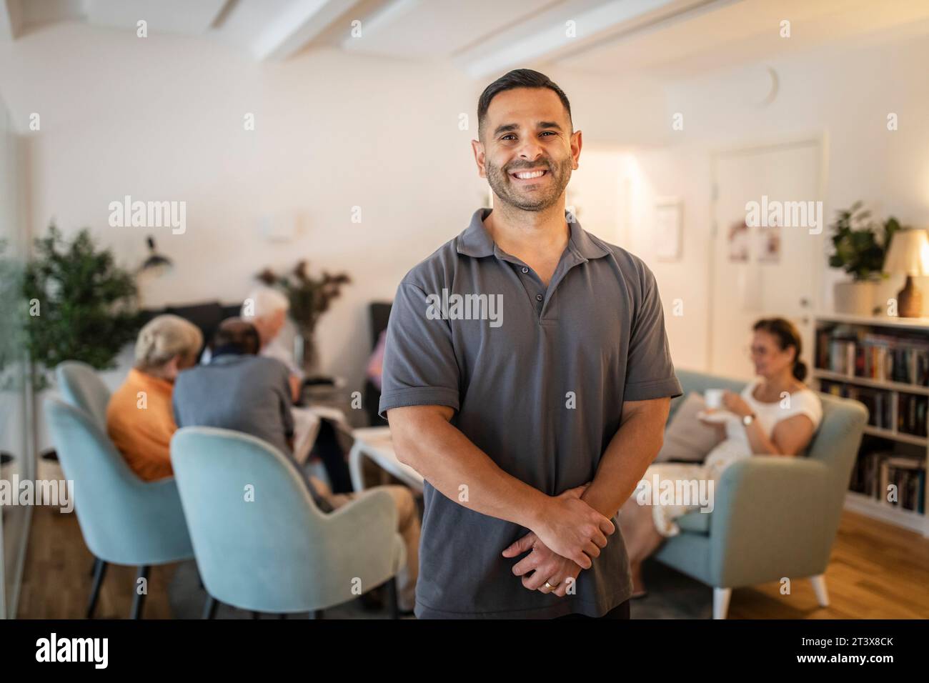 Portrait of smiling male nurse standing at nursing home Stock Photo - Alamy