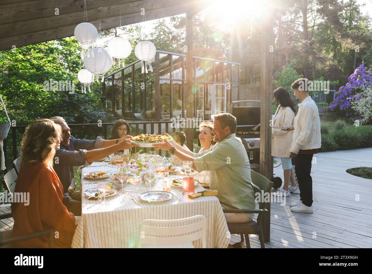 Family and friends enjoying summer dinner at patio in back yard Stock ...