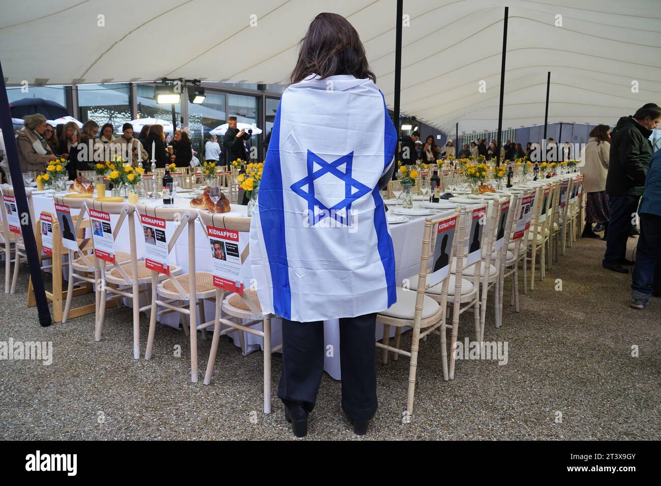 People viewing the Empty Shabbat Table installation, an empty dining ...