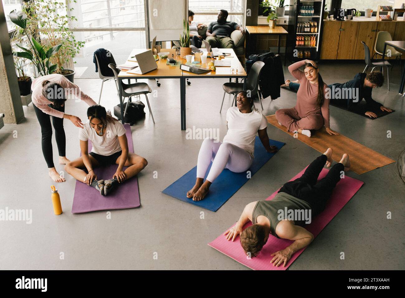 High angle view of multiracial colleagues exercising together at ...